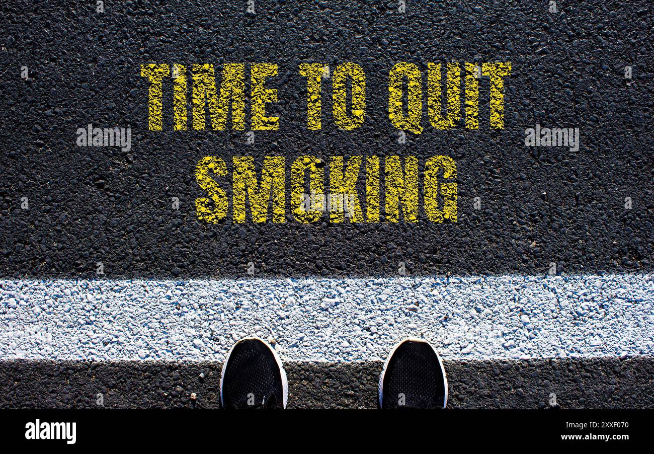 Time to quit smoking message written on asphalt road. Conceptual time ...