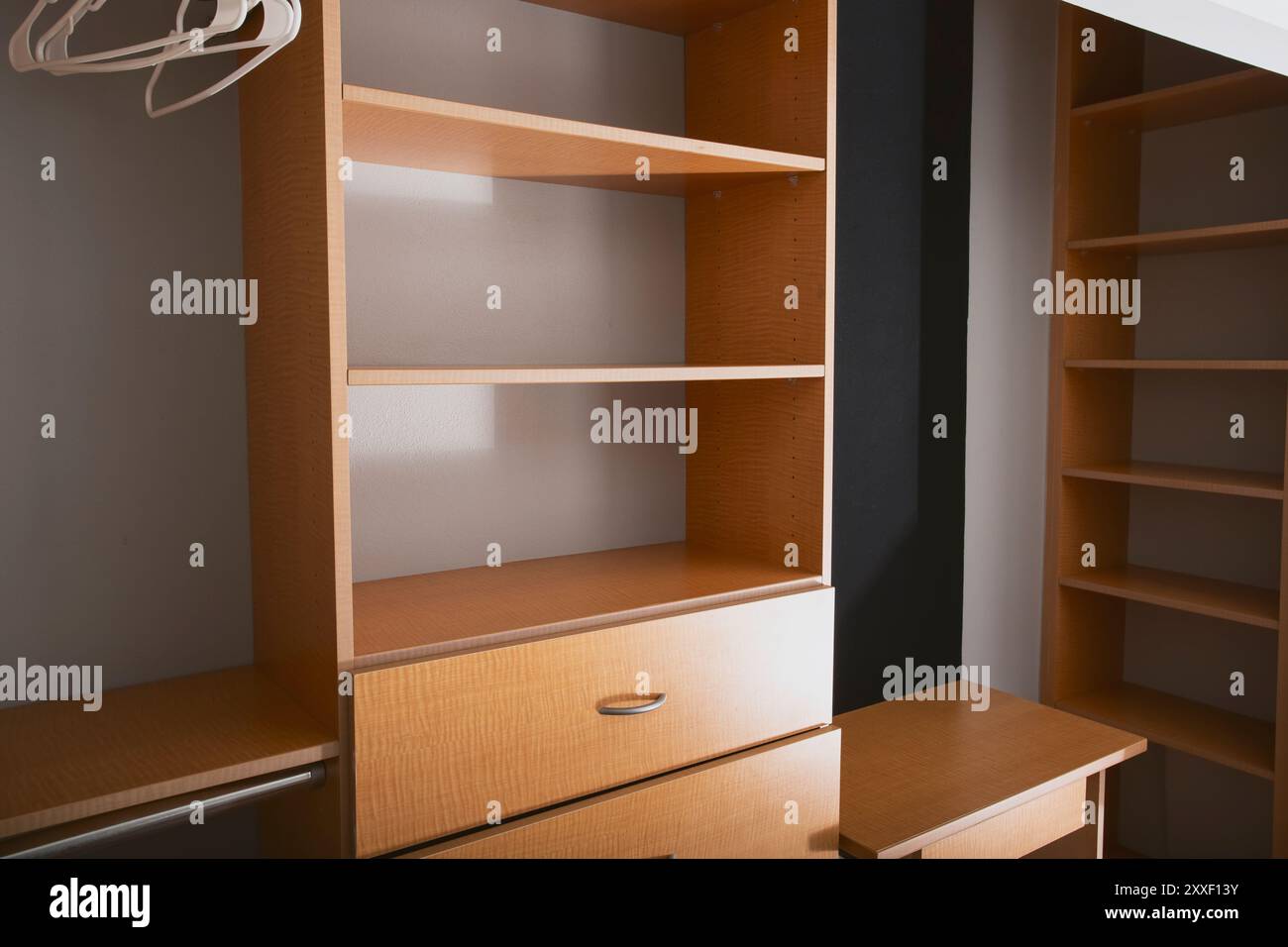 A view of a closet, featuring a wood shelving system Stock Photo - Alamy