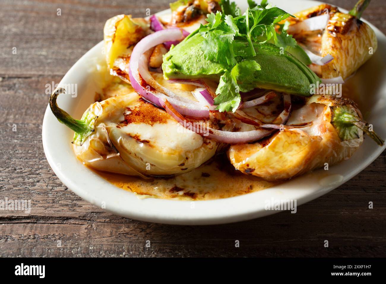 A view of a plate of stuffed yellow chiles called chiles toritos Stock ...