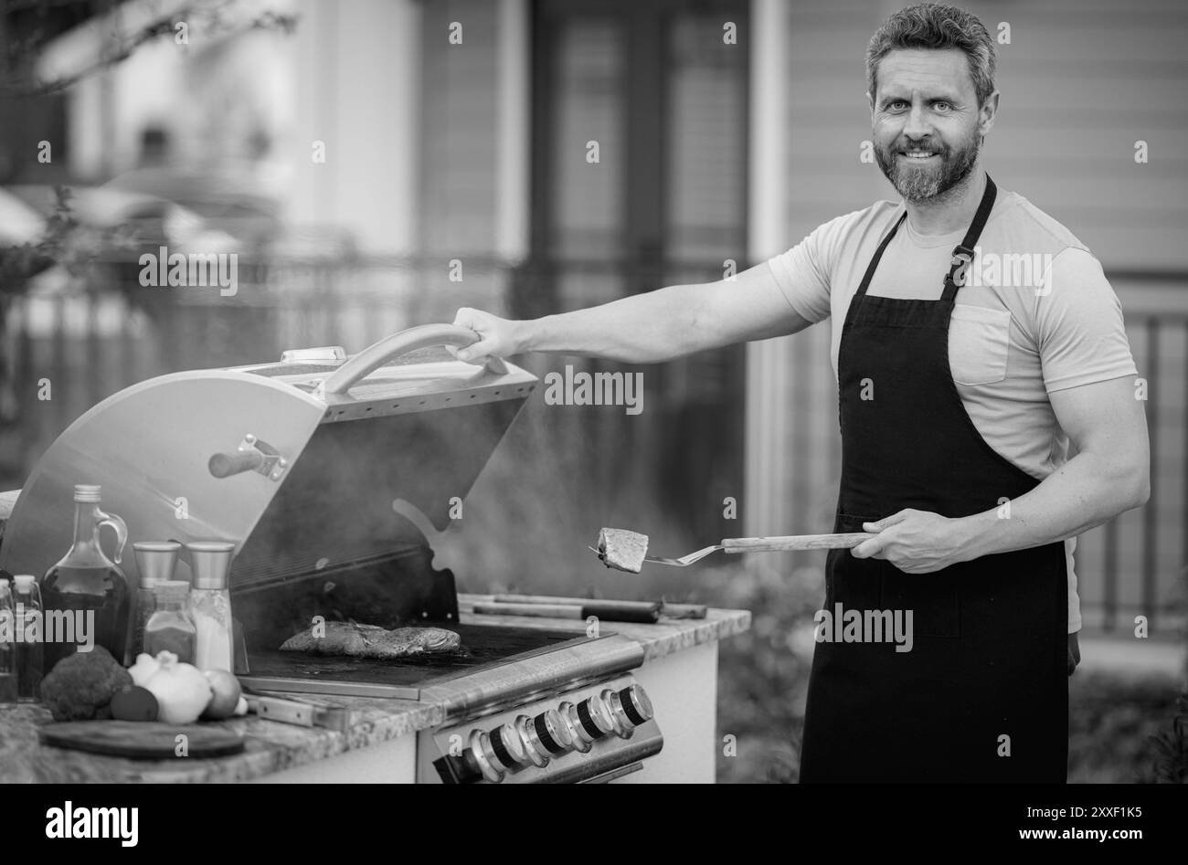 Cooking roast dinner in kitchen Black and White Stock Photos & Images ...