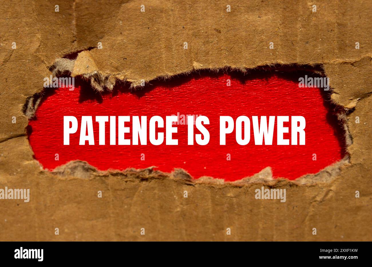 Patience is power message written on torn cardboard paper with red ...