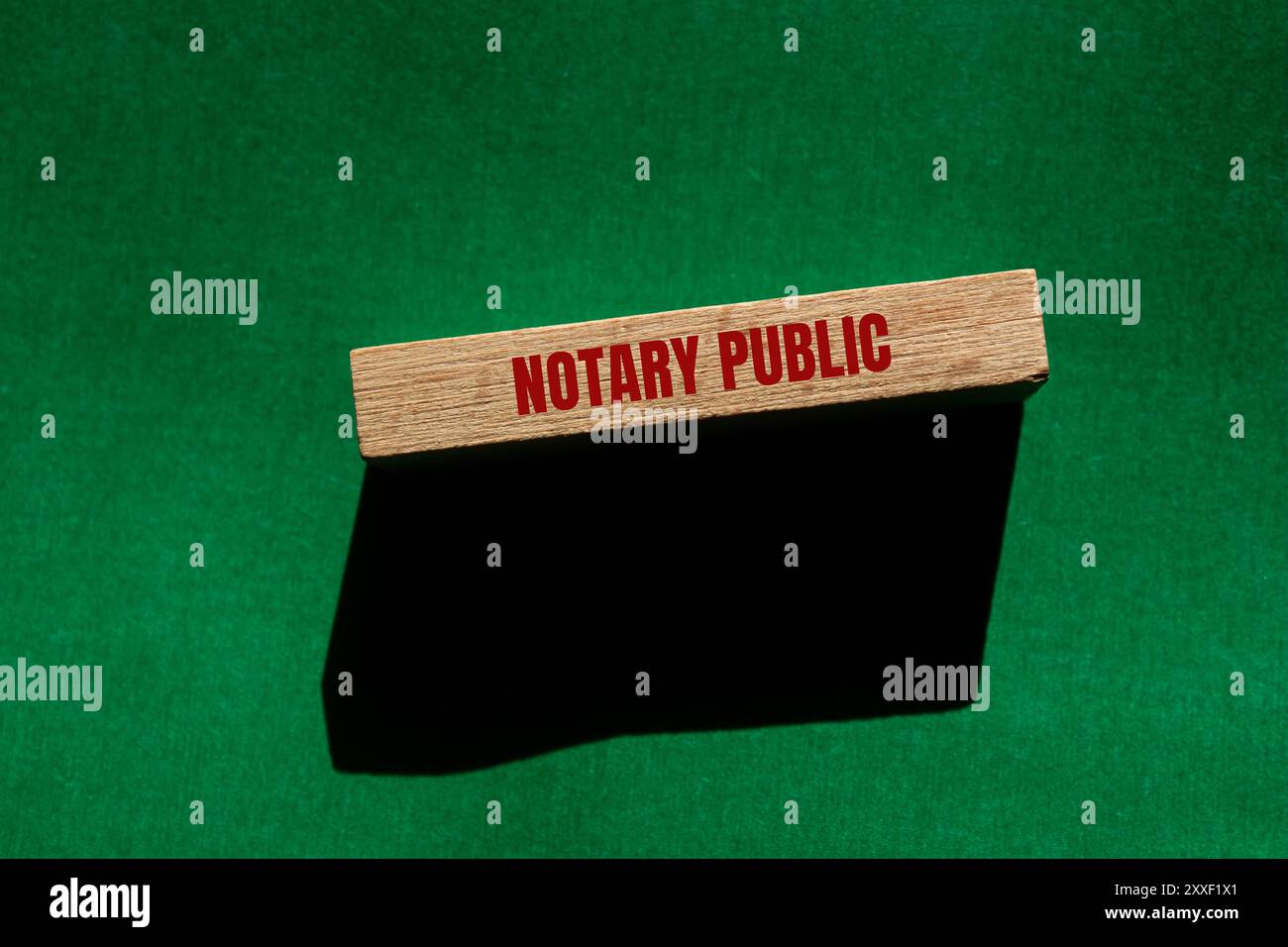 Notary public message written on wooden block with green background ...