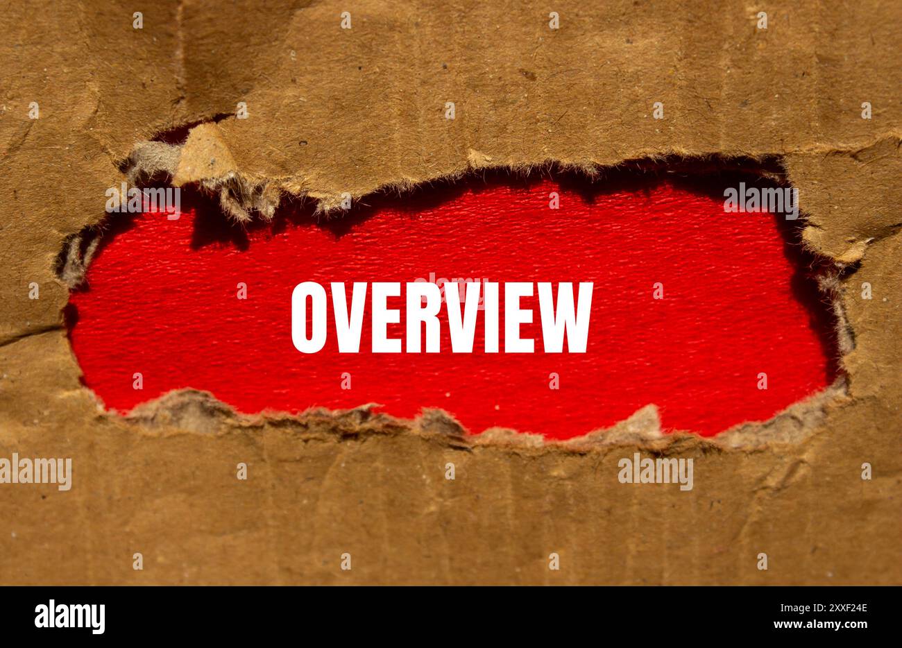 Overview message written on torn cardboard paper with red background ...