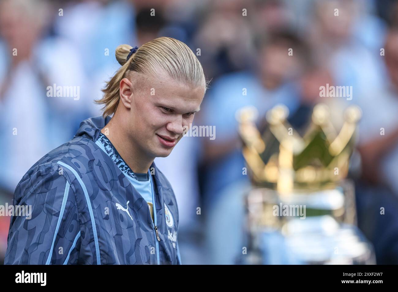Erling Haaland of Manchester City looks at the Premier League trophy as ...