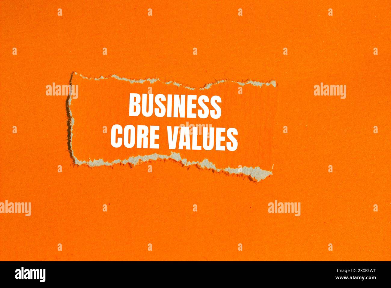 Business core values message written on ripped torn orange paper with ...