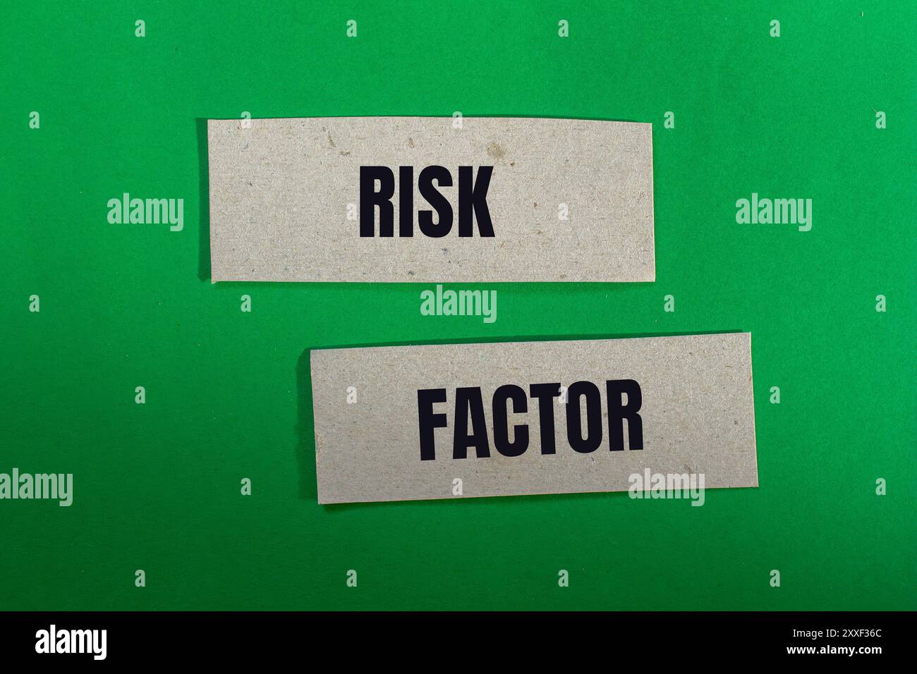 Risk factor message written on paper pieces with green background ...