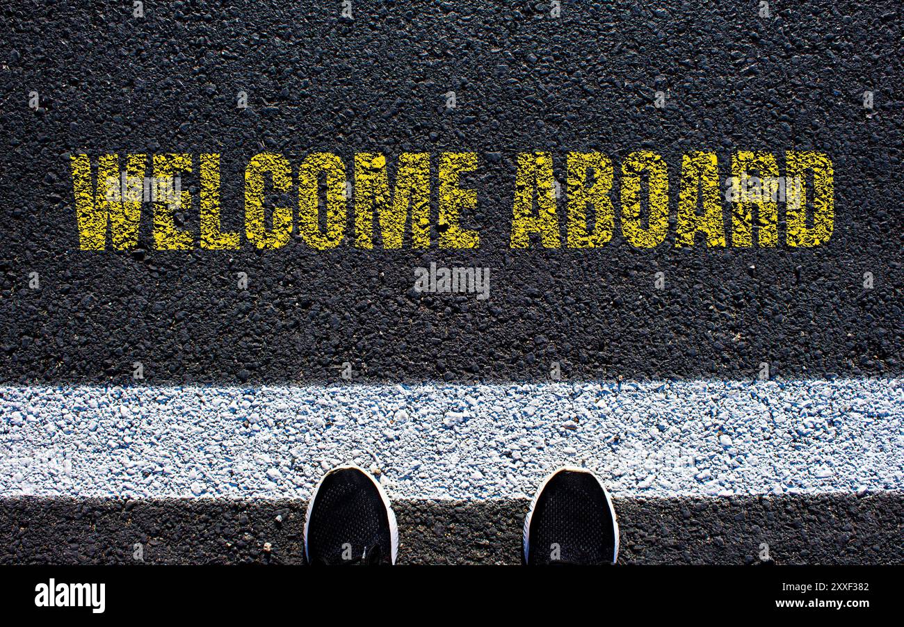 Welcome aboard message written on asphalt road. Conceptual welcome ...