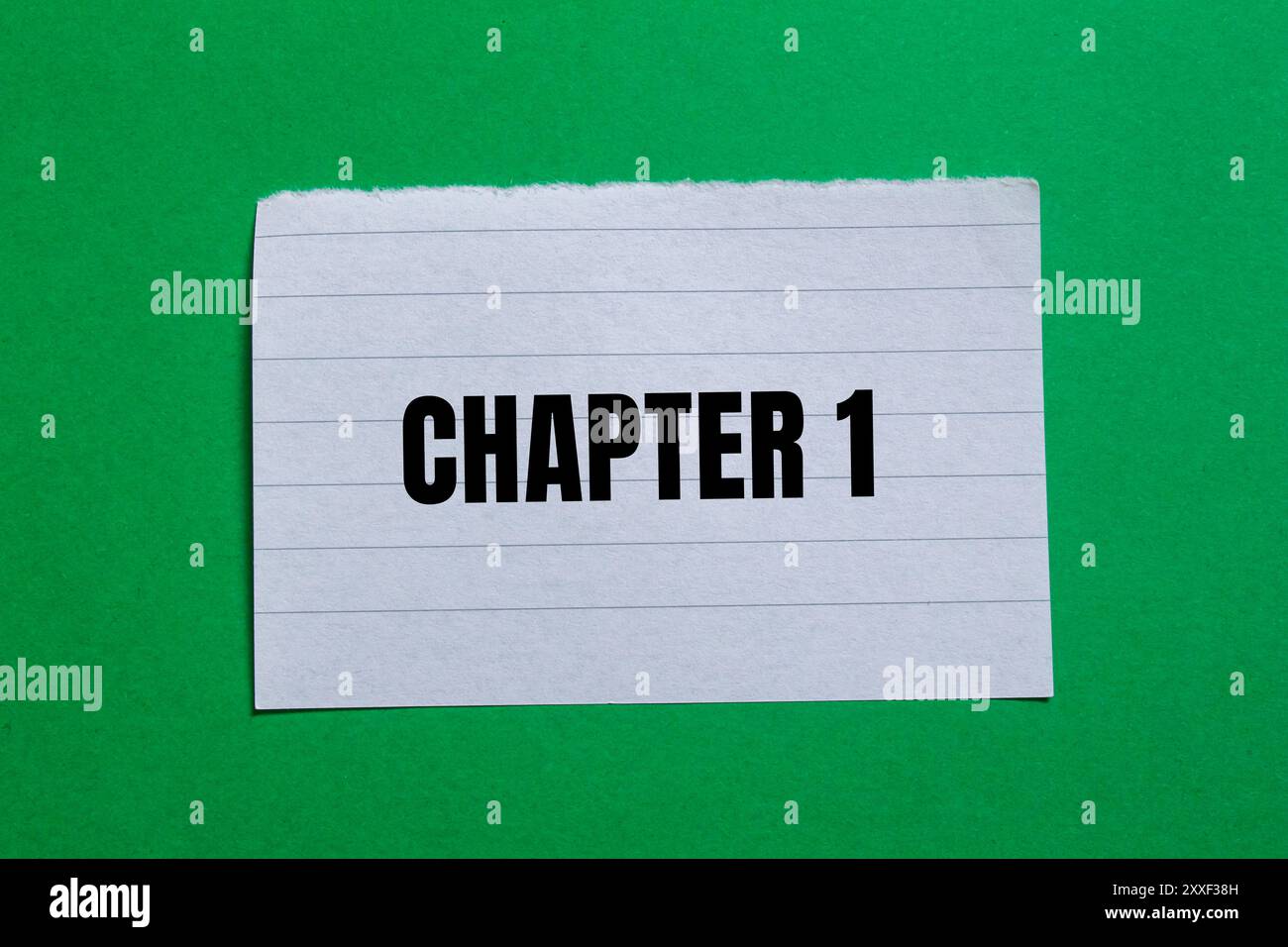 Chapter 1 message written on ripped torn paper piece with green ...