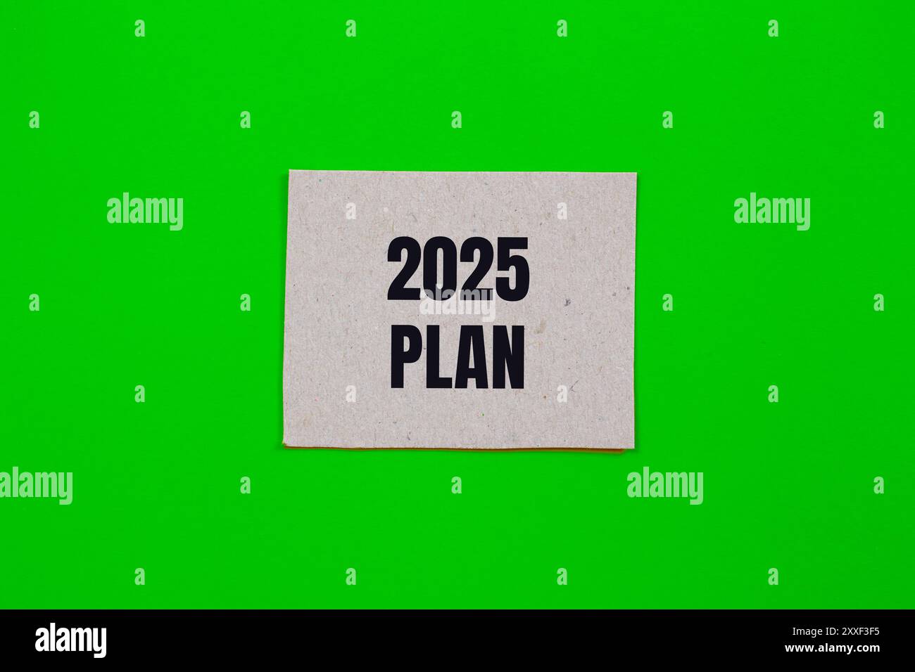 2025 plan message written on paper piece with green background ...