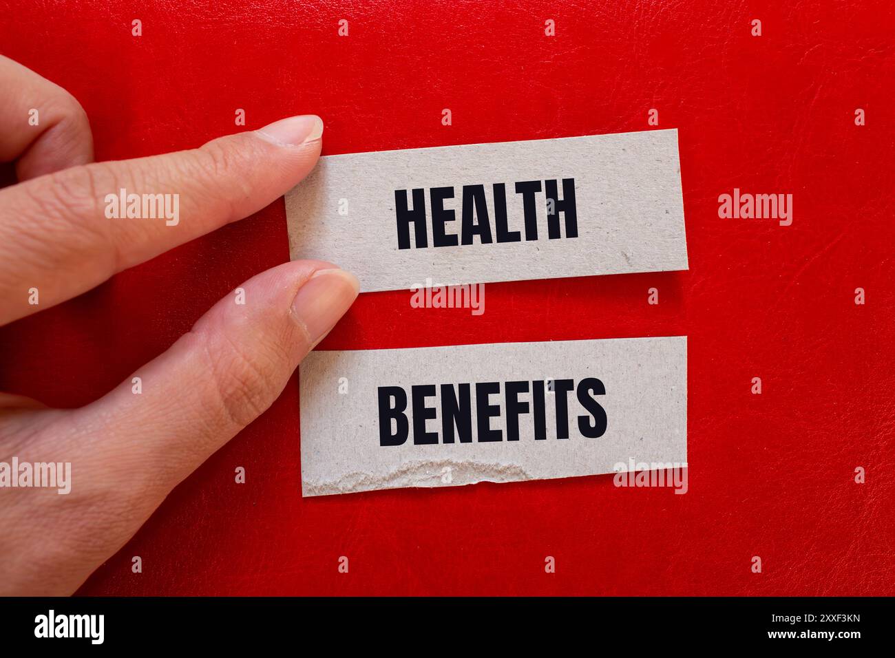 Health benefits message written on paper pieces with red background ...