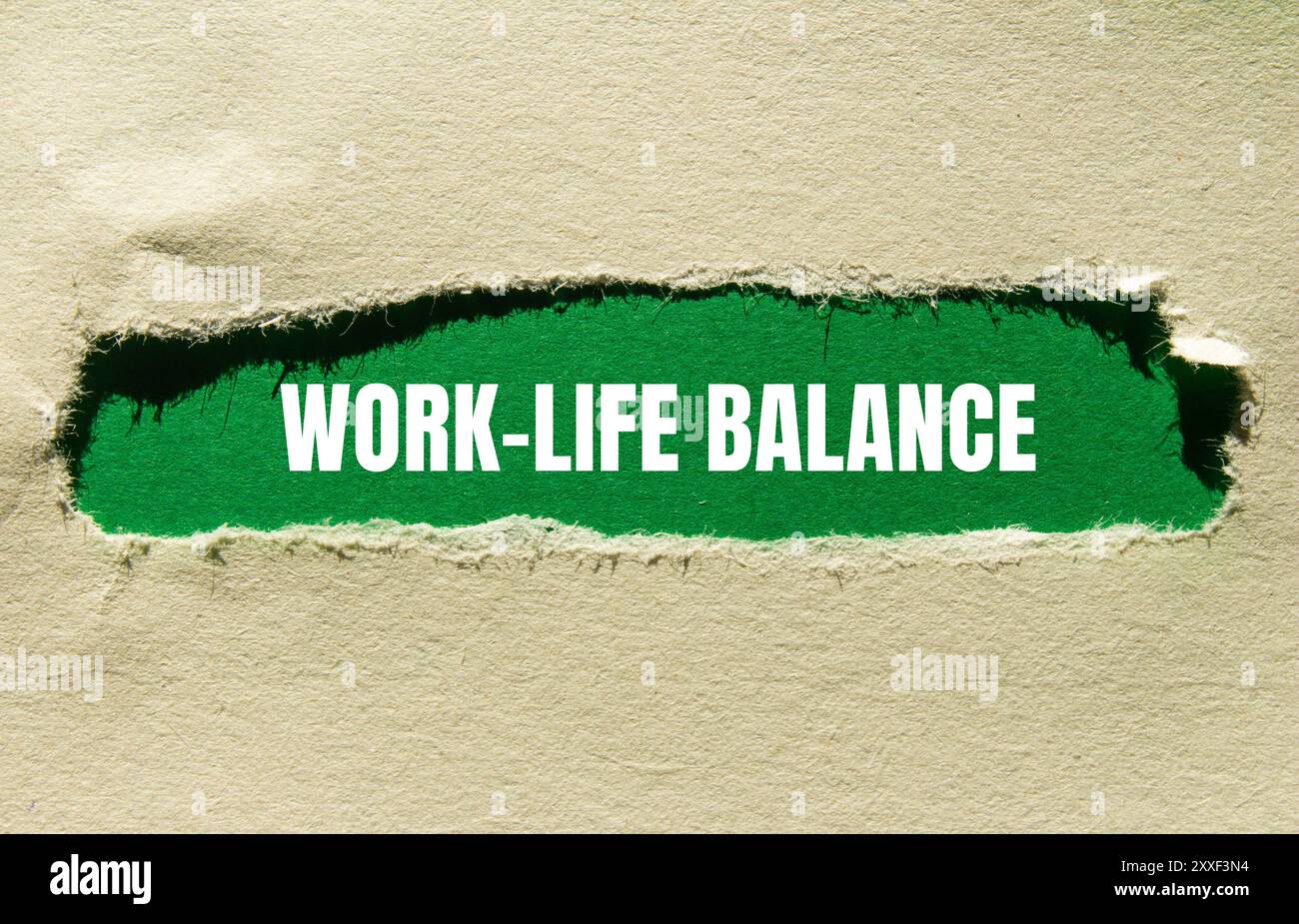 Work life balance message written on ripped torn paper with green ...