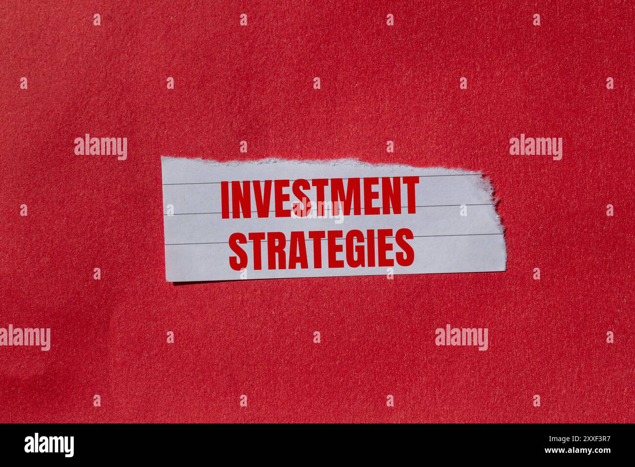 Investment strategies message written on ripped torn paper piece with ...