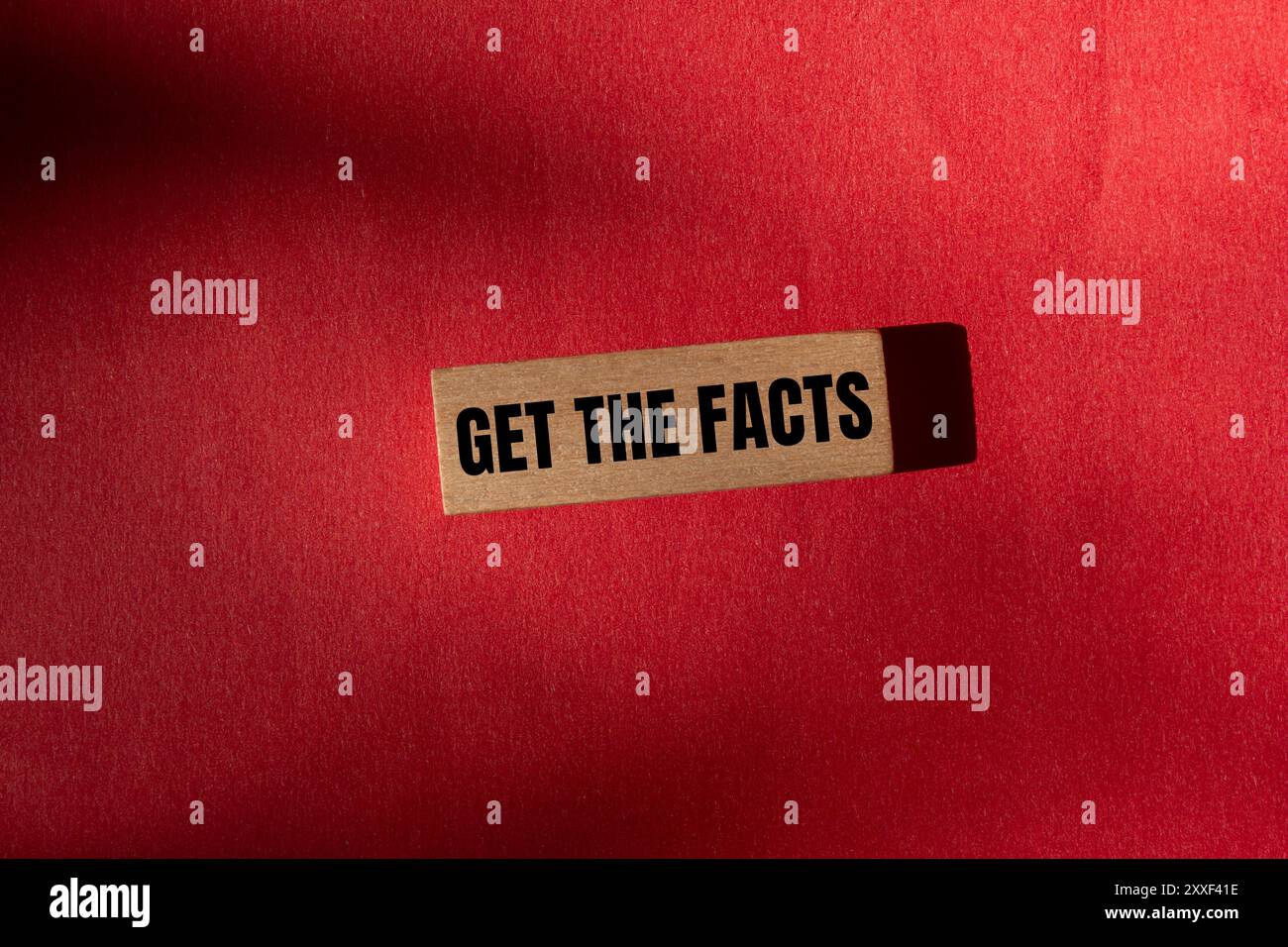 Get the facts message written on wooden block with red background ...
