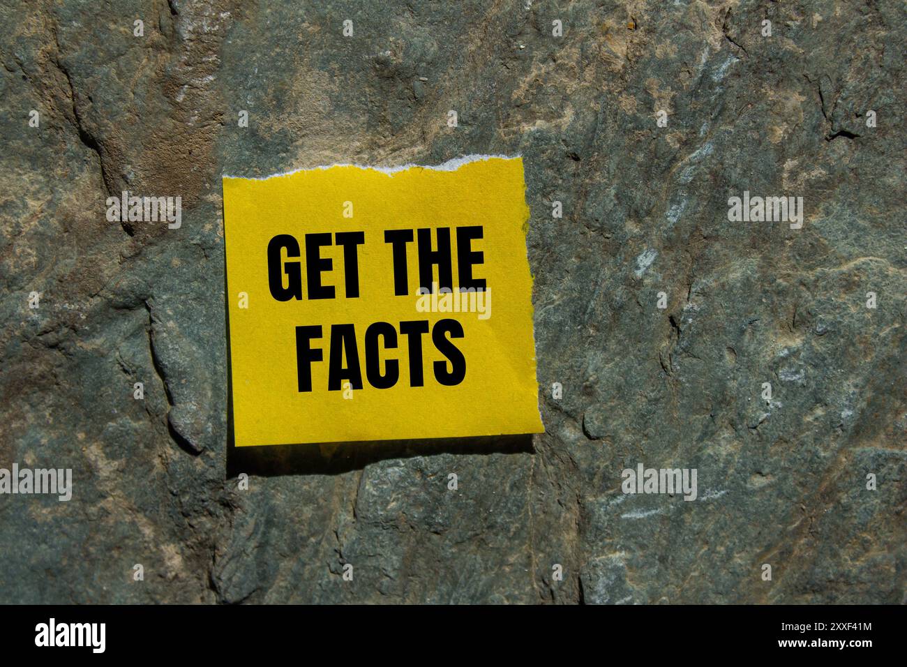 Get the facts message written on ripped yellow torn paper piece with ...