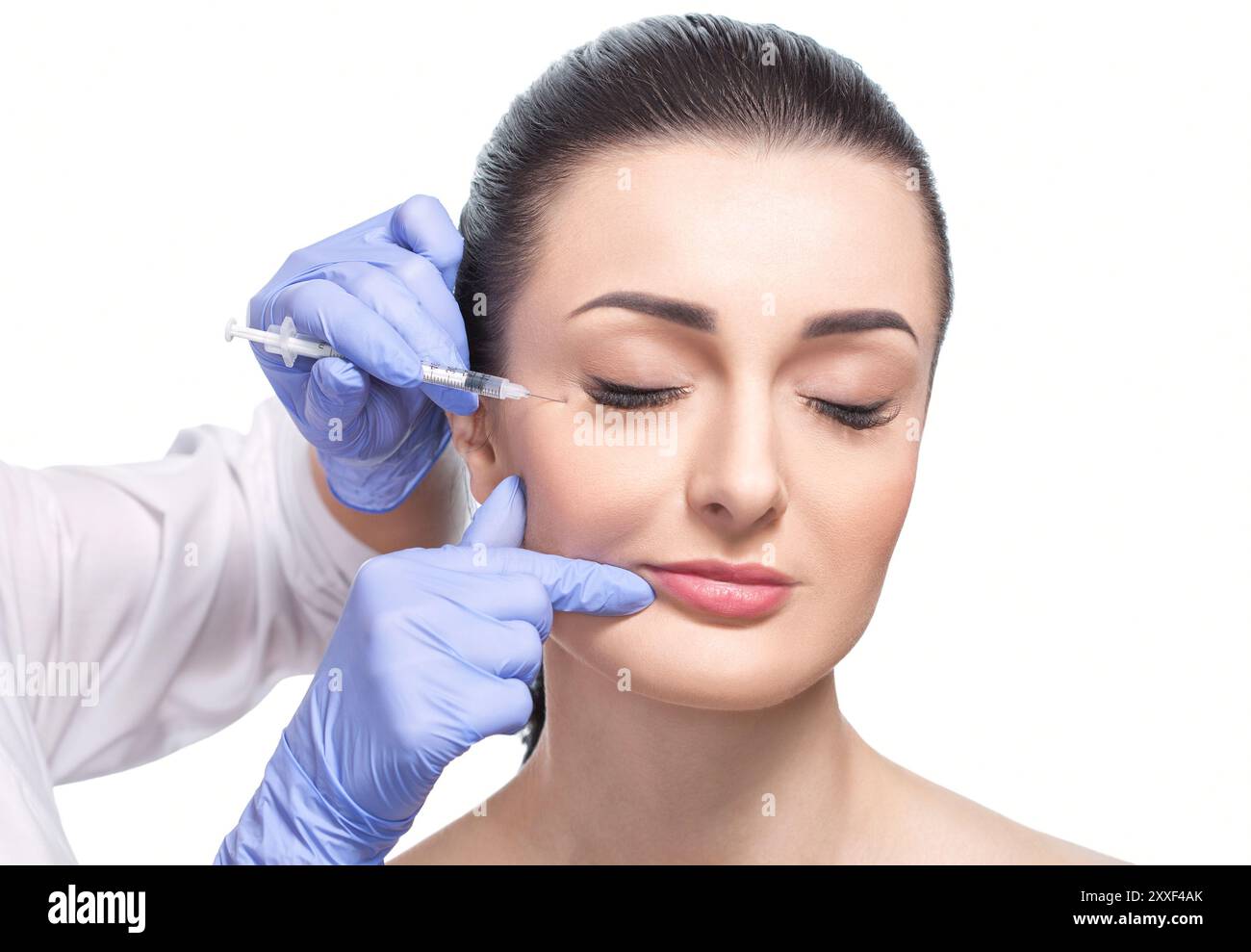 Cosmetologist makes rejuvenating anti wrinkle injections on the face of ...