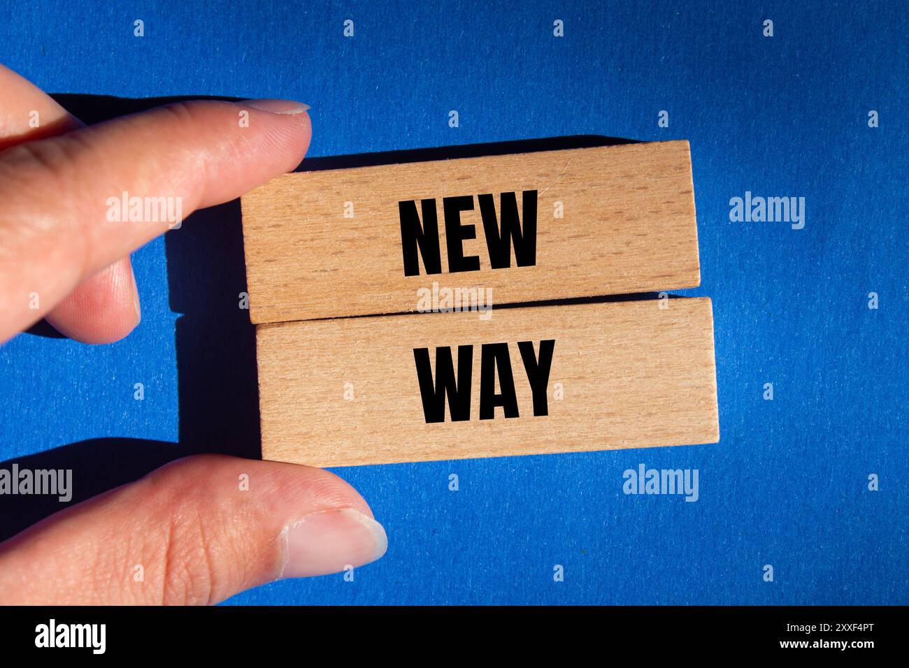 New way message written on wooden blocks on blue background. Conceptual ...