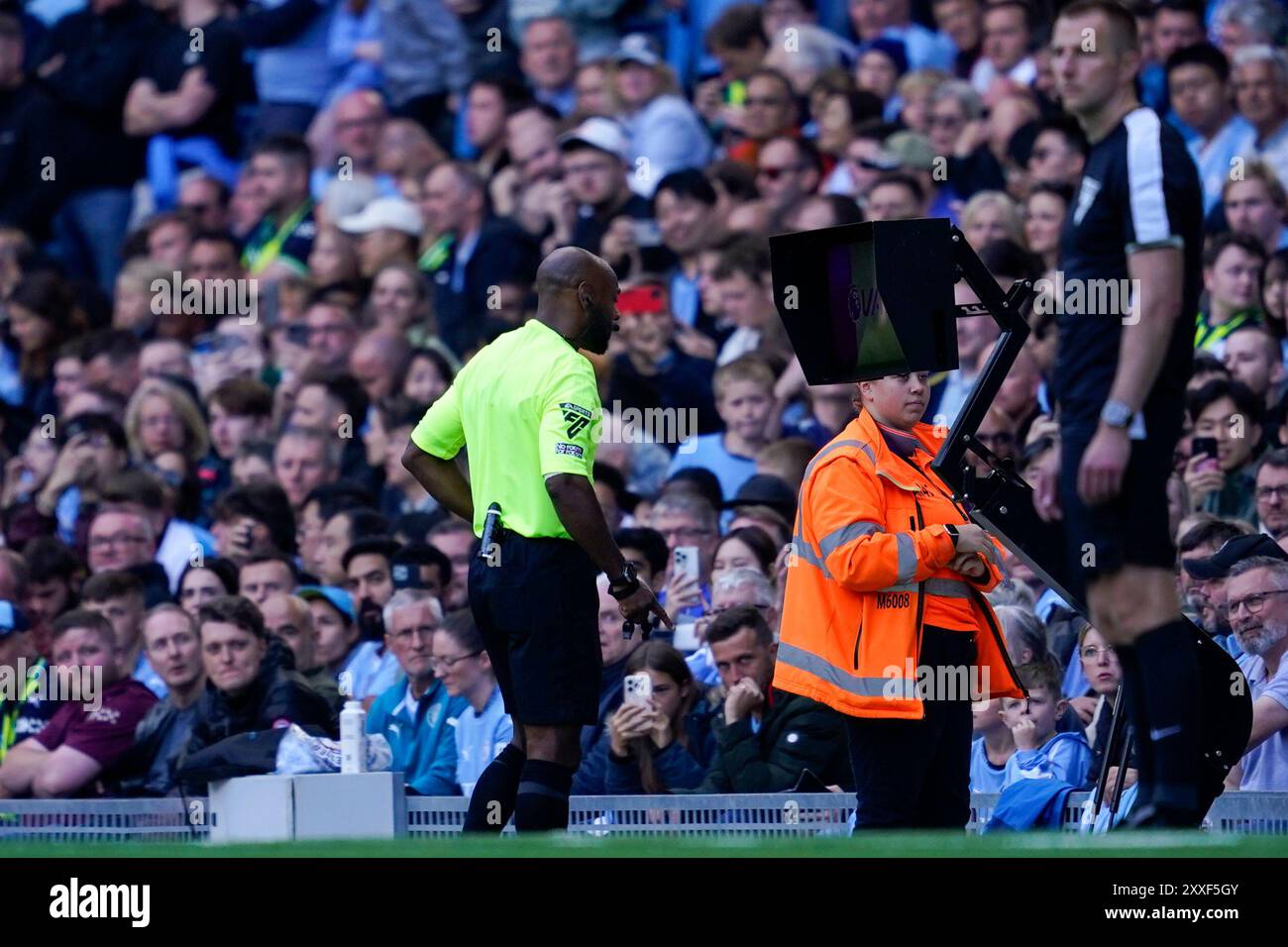 Referee Michael Salisbury, left, checks VAR screen during the English ...