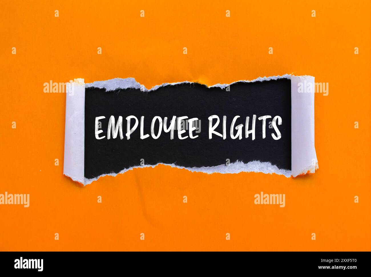 Employee rights message written on ripped torn orange paper with black background. Conceptual ...