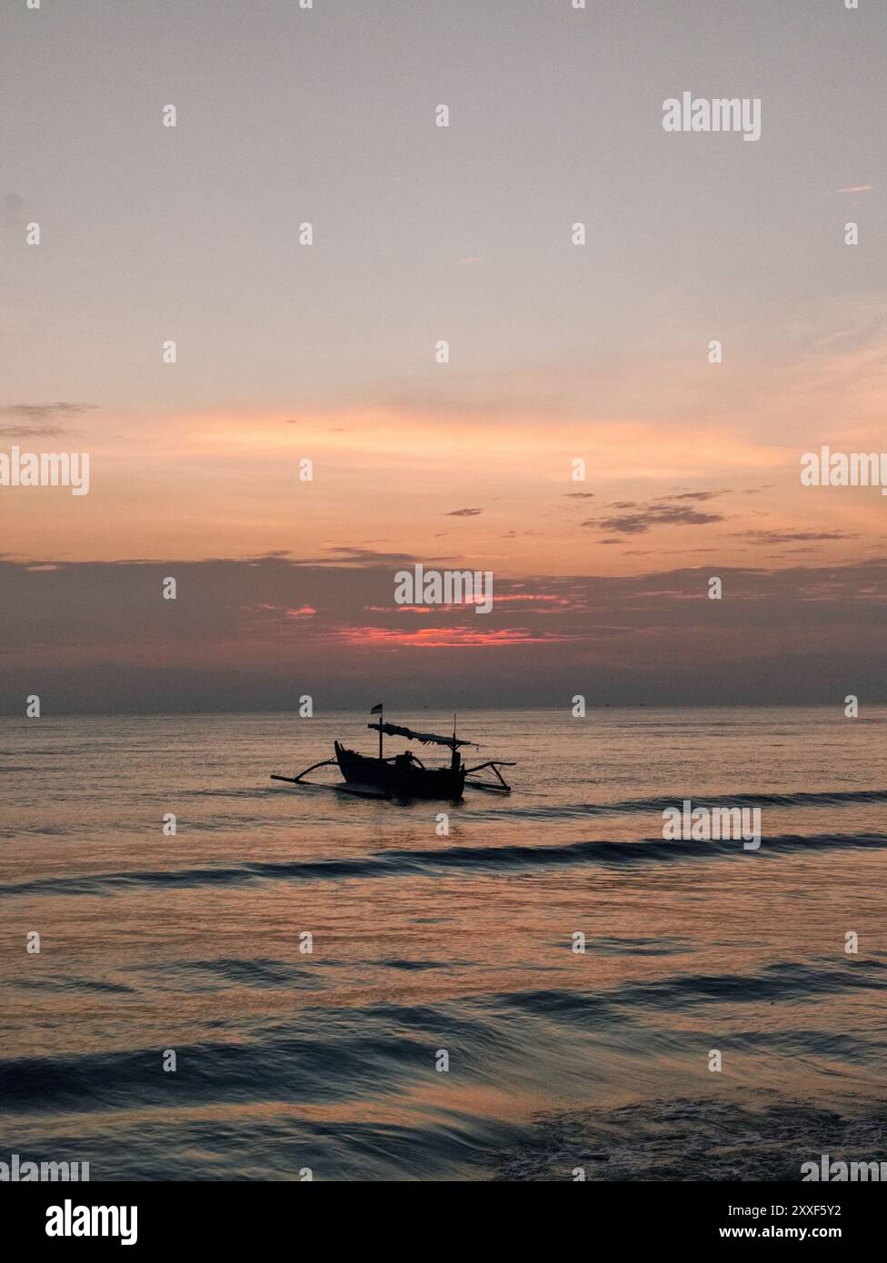 a fishing boat anchored on the north coast of Java, Indonesia with a ...