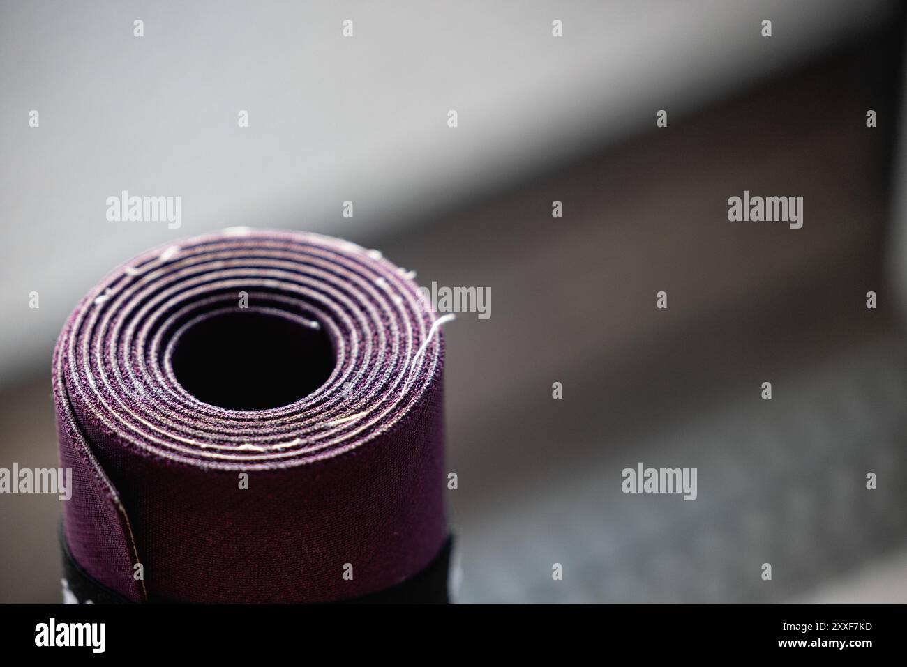 A yoga mat viewed from above, showing a rolled-up mat. Materials for ...
