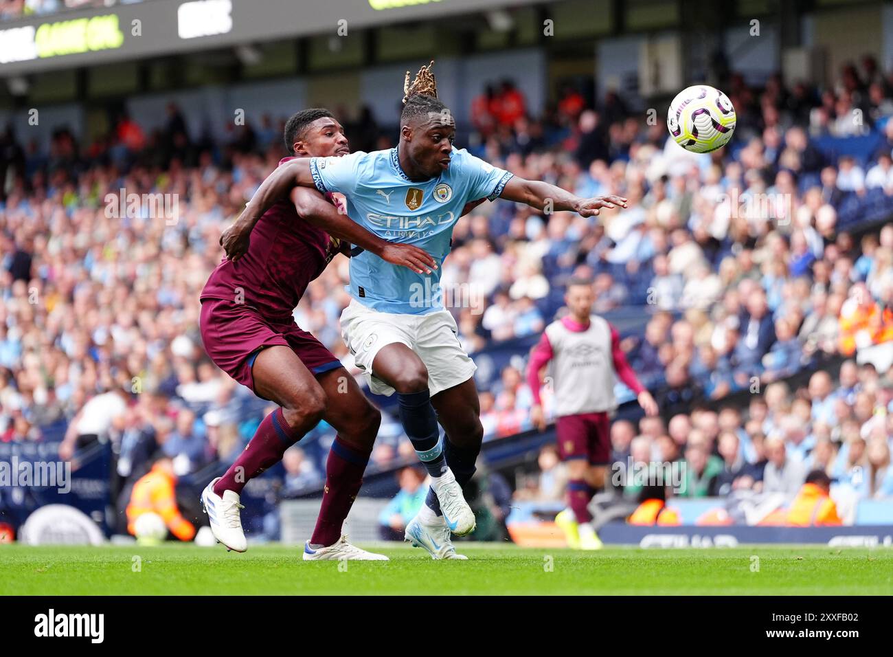 Ipswich Town's Ben Johnson (left) and Manchester City's Jeremy Doku ...