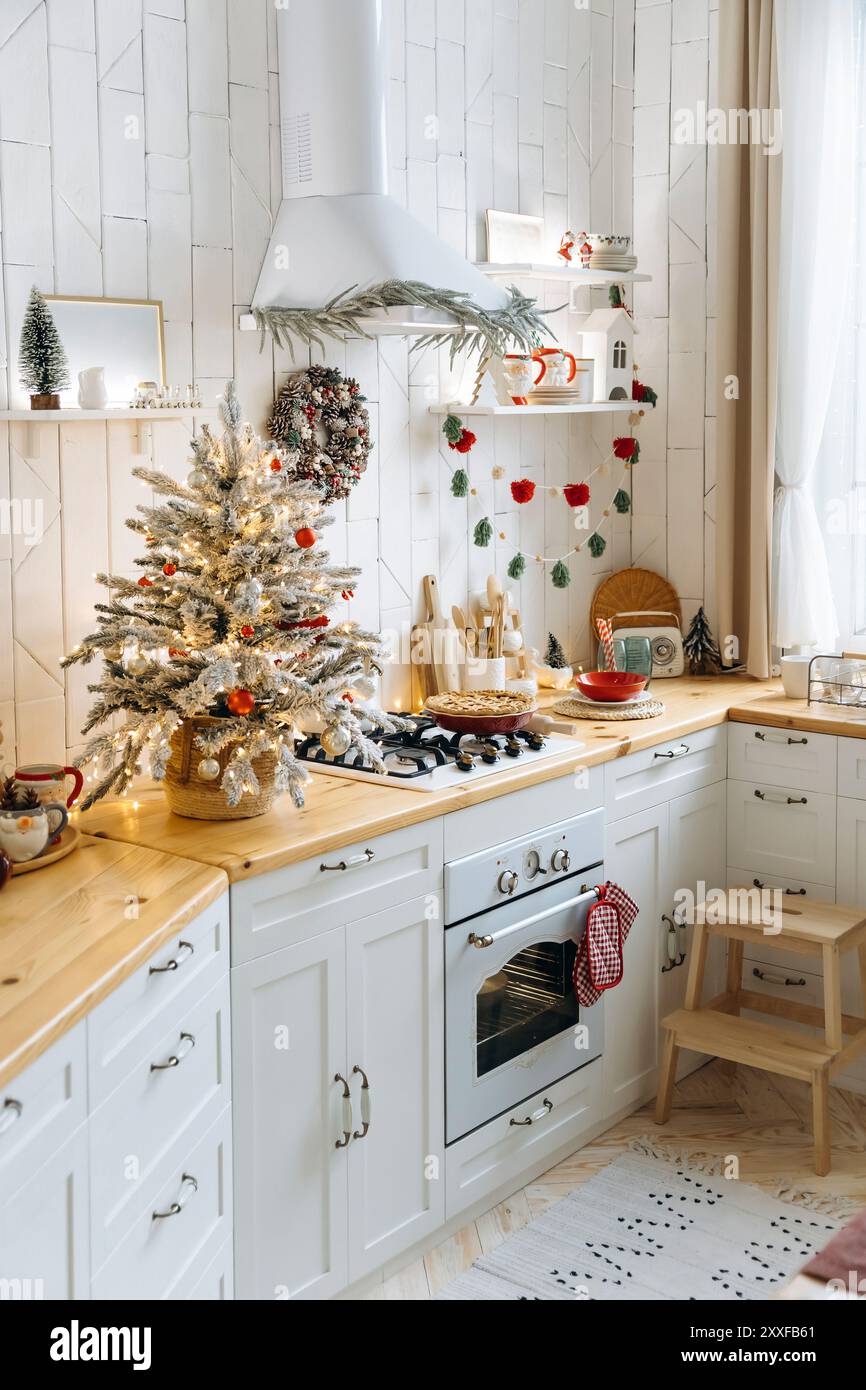 Holiday kitchen decor with a Christmas tree on the counter, pinecone ...