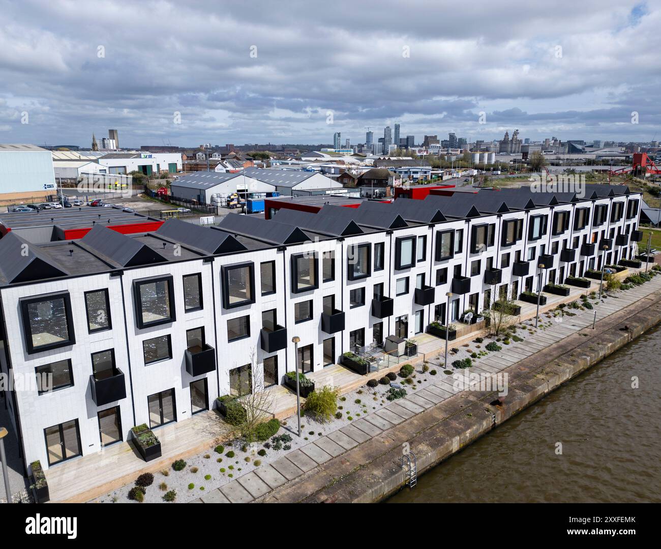 Aerial slow approach of energy efficient modular homes by Wirral Waters ...