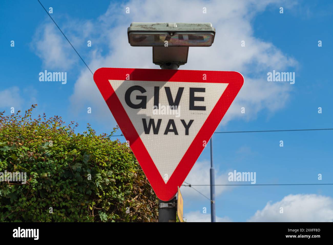 UK Traffic sign stating give way ahead on a red and white warning ...