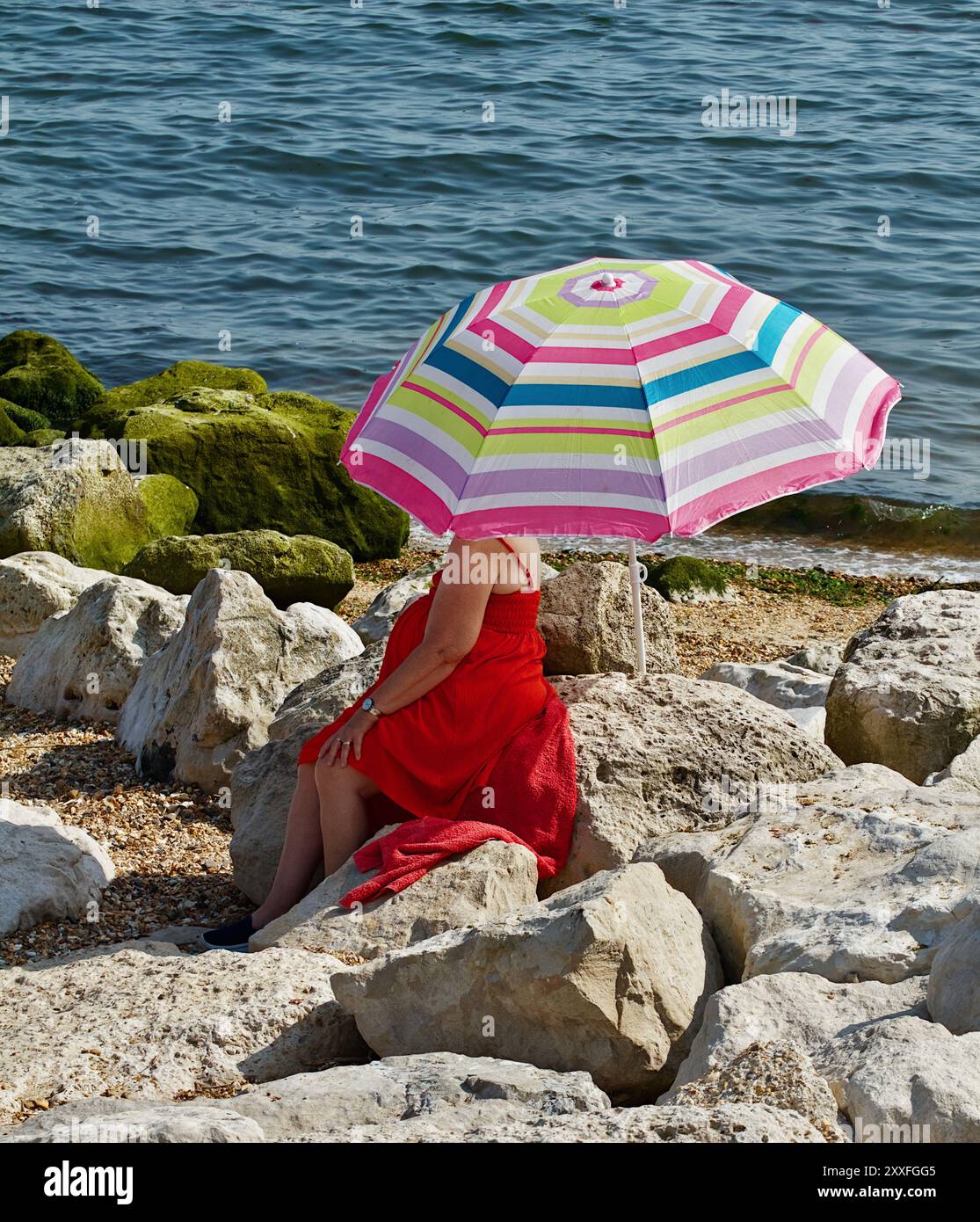 Woman In Bright Red Dress Sheltering Under A Colourful Umbrella Sitting ...