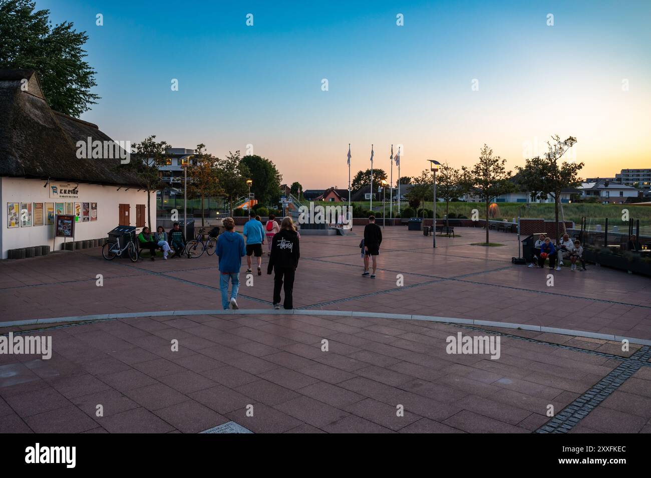 Dahme, Germany, July 20, 2024 - Teenage tourists walking at the dyke ...