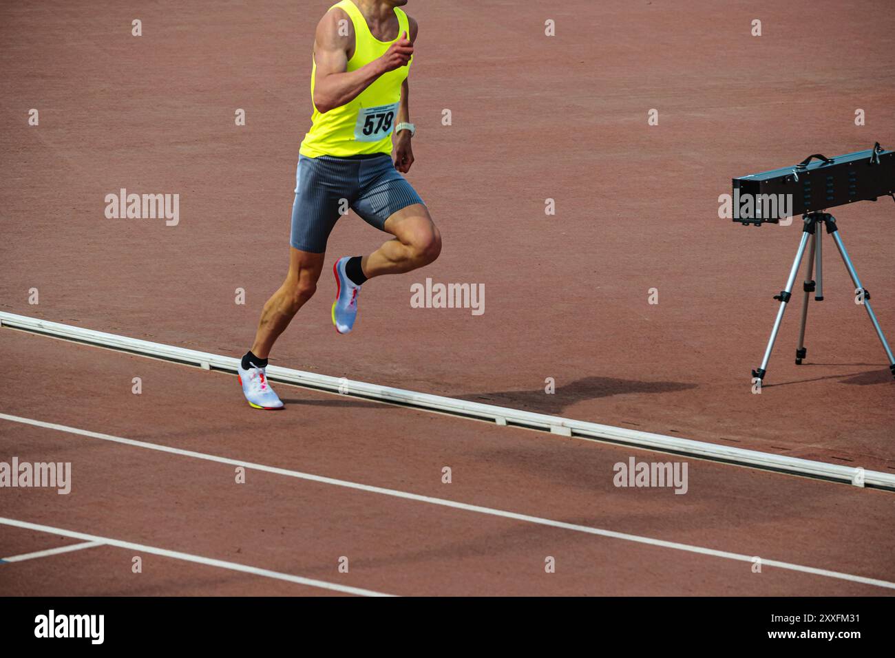 athlete running middle-distance race near electronic scoreboard Stock ...