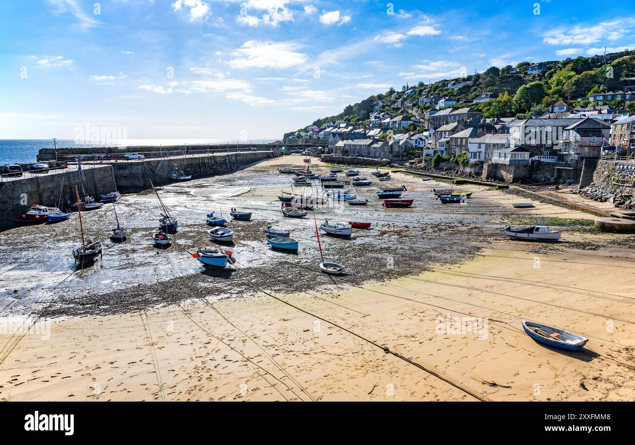 Low tide at the tiny harbour of Mousehole, Cornwall, England, UK Stock ...
