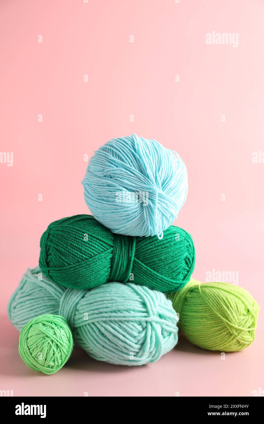 Pile of different colorful yarns on pink background Stock Photo - Alamy