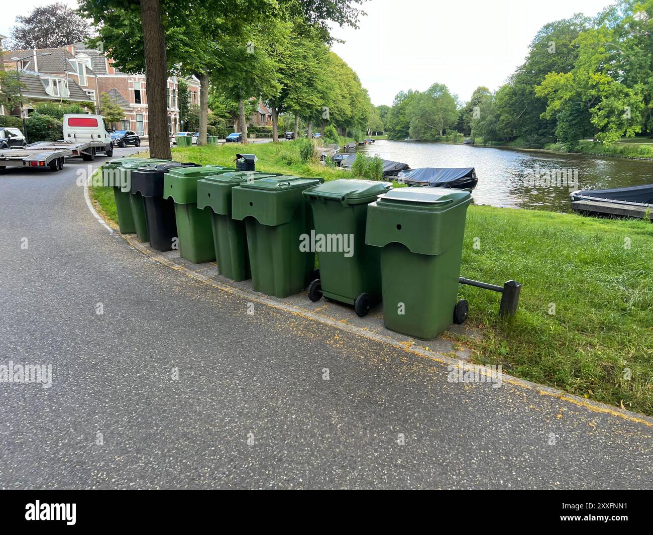 Many green trash bins on city street Stock Photo - Alamy