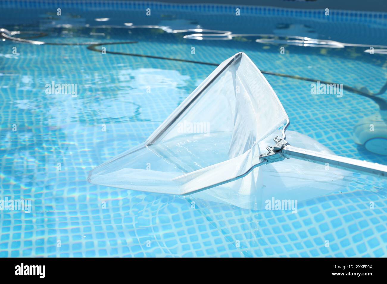 Cleaning swimming pool with skimmer net, closeup Stock Photo - Alamy