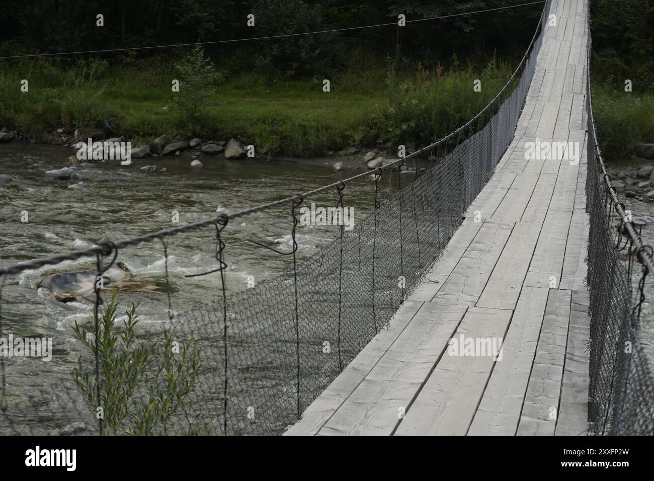 Suspension bridge over mountain river hi-res stock photography and ...