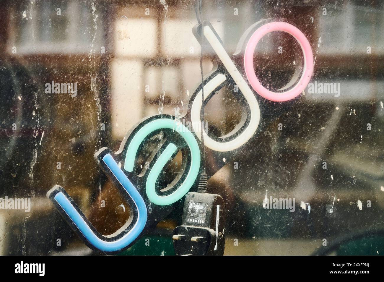 Switched off and fallen neon sign in empty shop window Stock Photo - Alamy