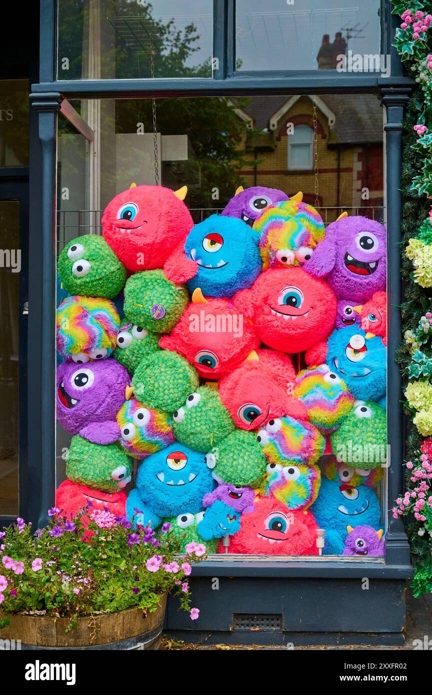 Colourful soft toys stacked inot shop window Stock Photo - Alamy