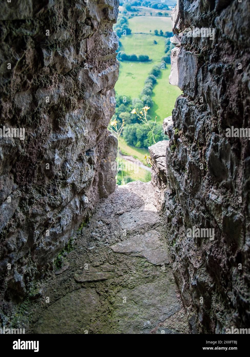 View of river cennen hundreds of feet below through a narrow slit in ...