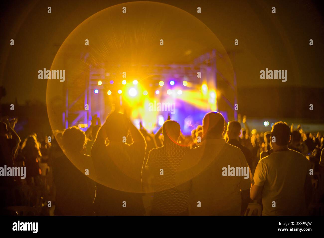 Vibrant rock concert scene with an enthusiastic crowd and bright stage ...