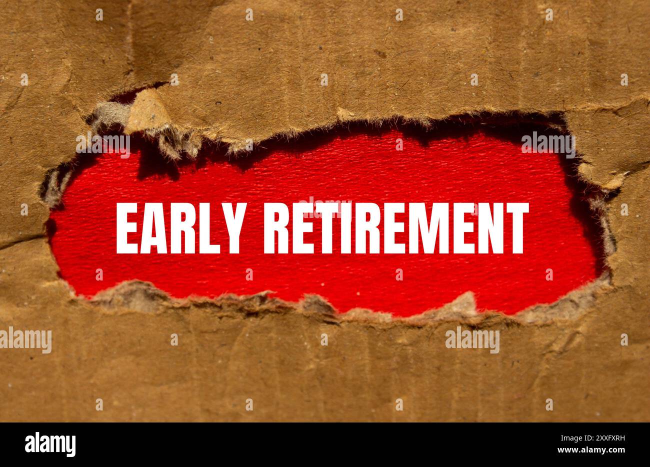 Early retirement message written on torn cardboard paper with red ...