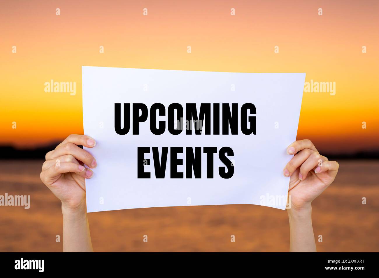 Upcoming events message written on white paper with blurry lake ...