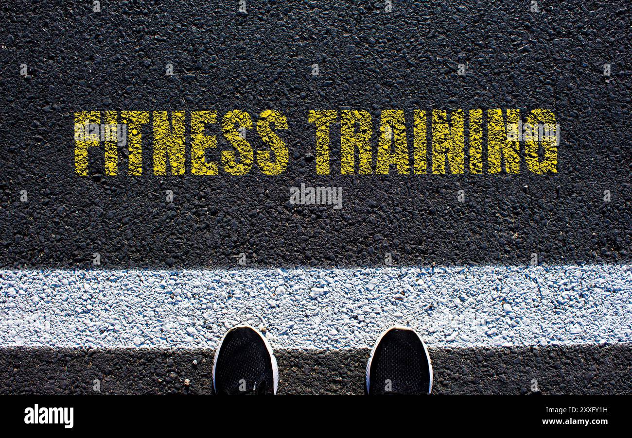Fitness training message written on asphalt road. Conceptual fitness ...