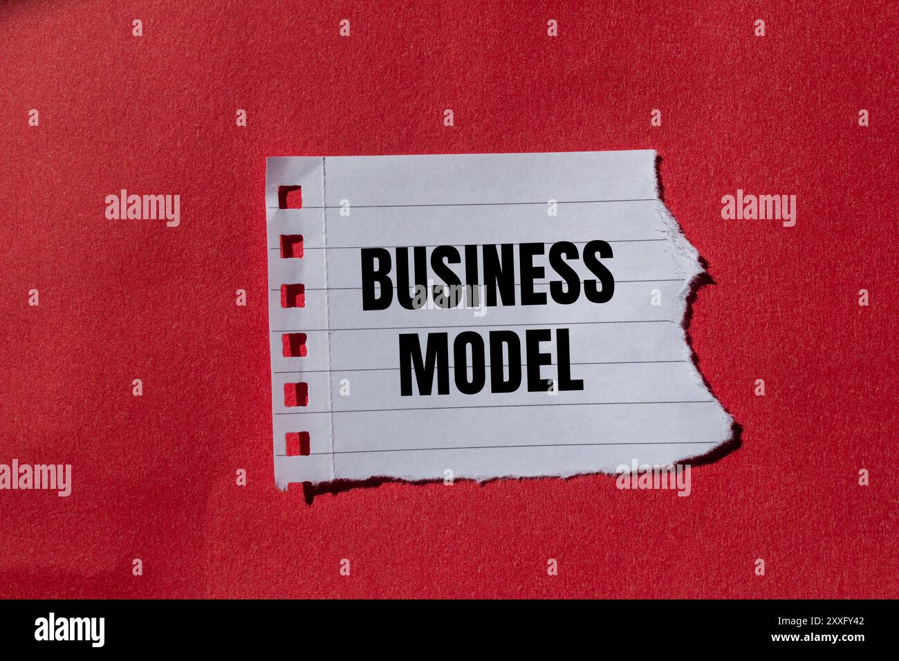 Business model message written on ripped torn paper with red background. Conceptual business ...
