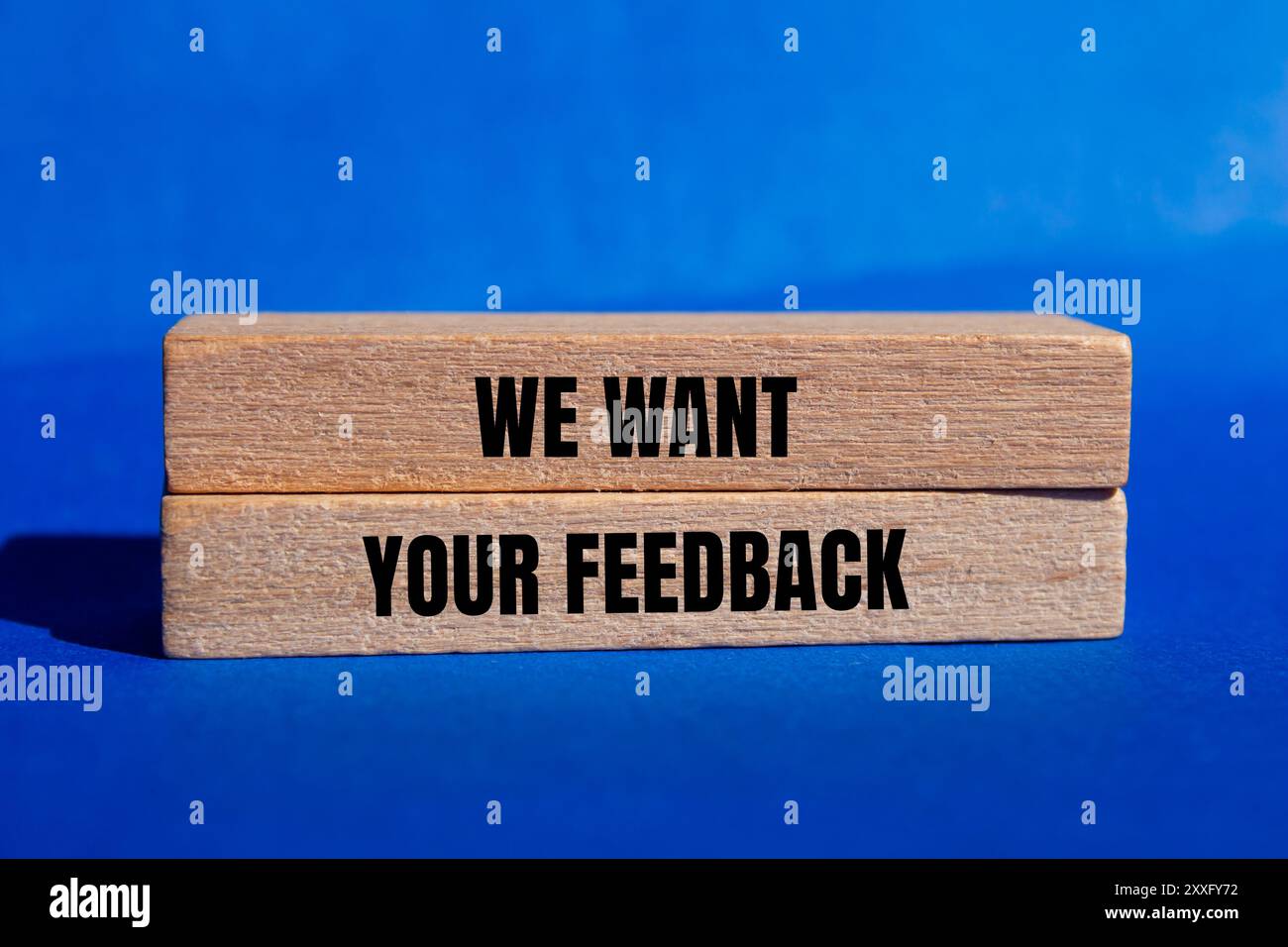 We want your feedback message written on wooden blocks with blue ...