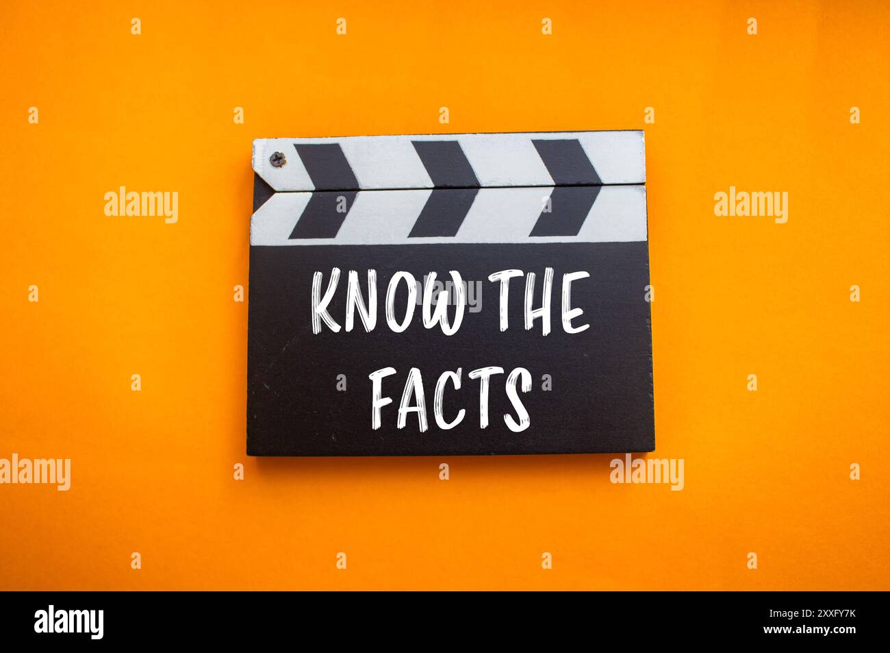 Know the facts message written on movie clapper board with orange ...
