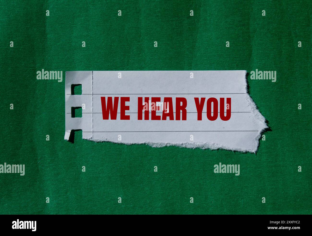 We hear you message written on ripped torn paper with green background. Conceptual we hear you ...