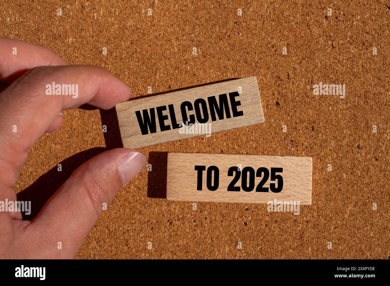 Welcome to 2025 message written on wooden blocks with brown background ...