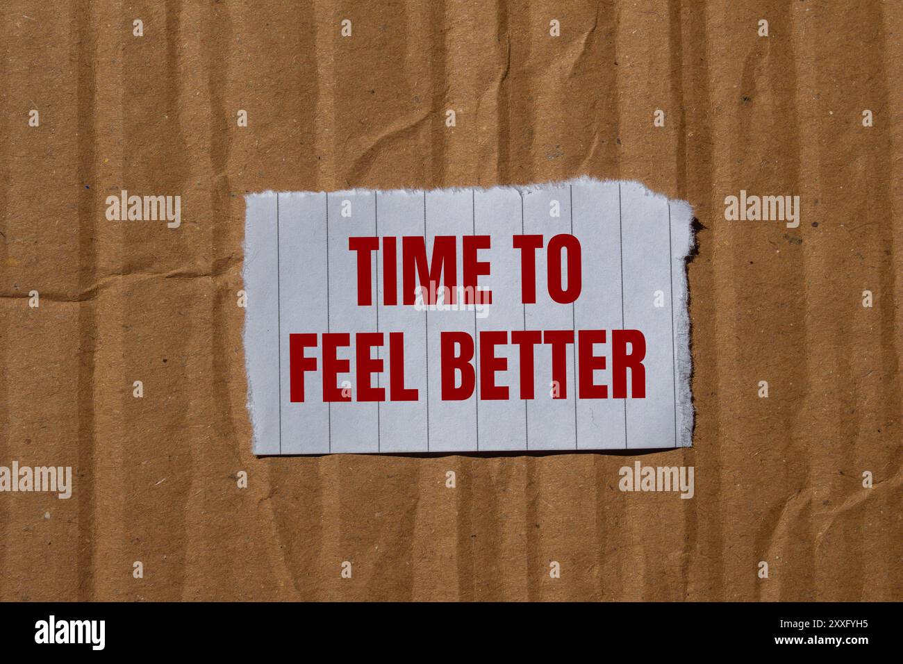 Time to feel better message written on ripped torn paper with cardboard ...