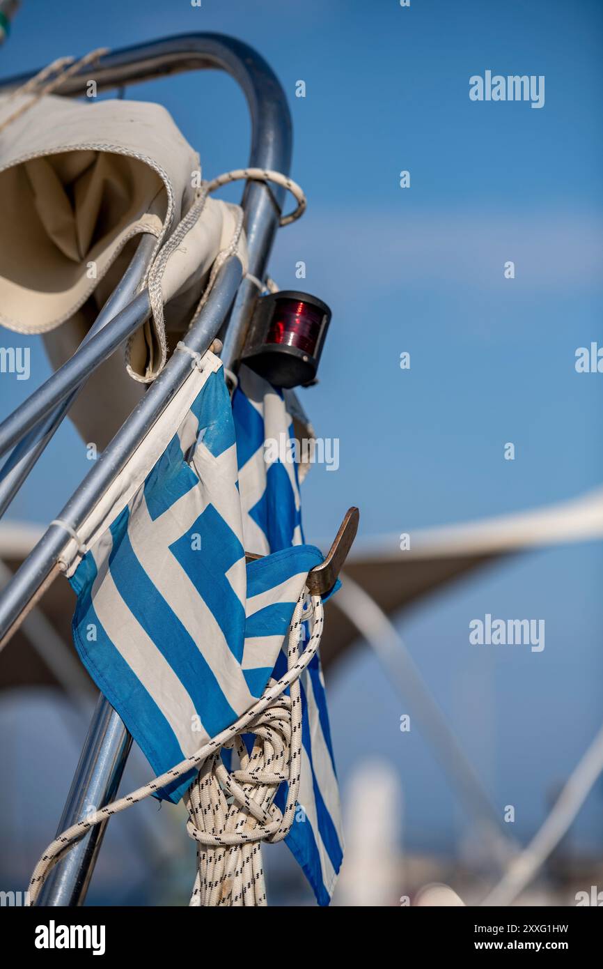 greek national flag on a small boat mast tangled in the rigging Stock ...